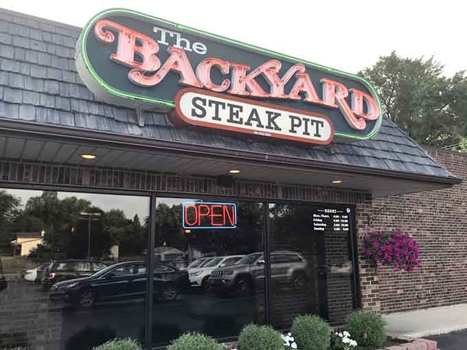 That glowing neon "OPEN" sign is basically a beacon calling all steak lovers to come taste something truly wonderful.