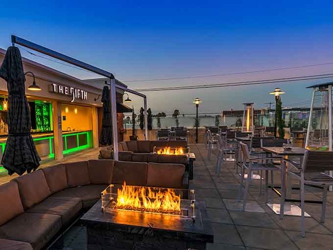 Twilight transforms fire pits into glowing gathering spots as the sky shifts from pink to purple.