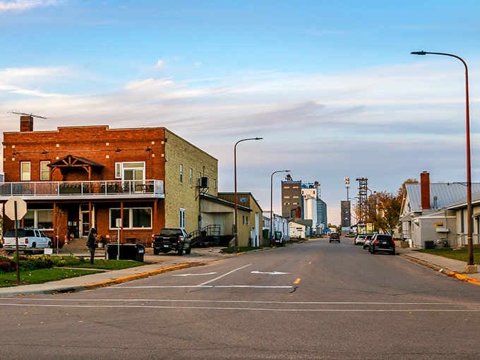 Grain elevators rise in the distance, honest reminders that this town's roots run deep in agricultural tradition.