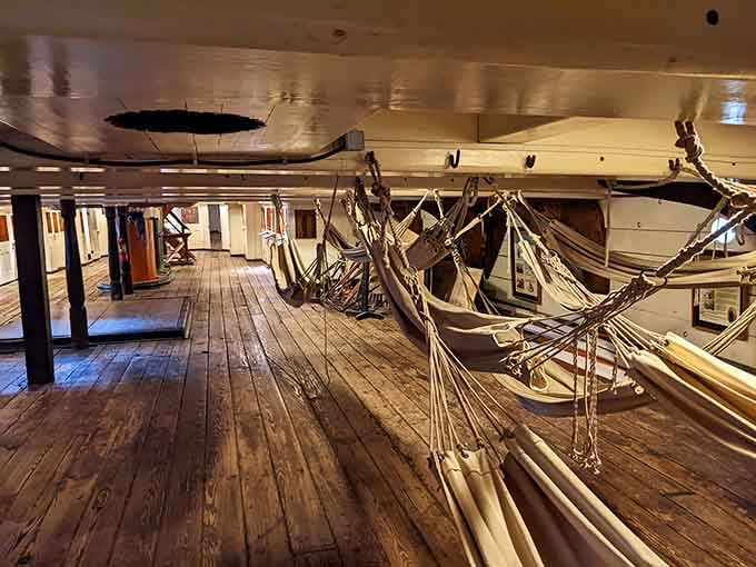 Below deck, those swaying hammocks and creaking timbers tell stories of sailors who lived hard lives at sea.