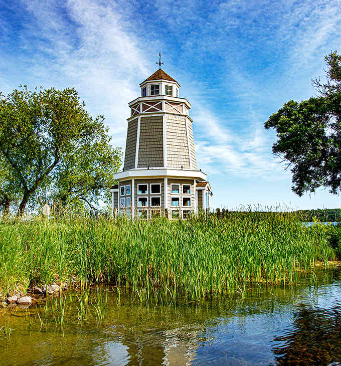 Cattails frame the octagonal tower like nature's own stage curtains, creating a peaceful scene worthy of a jigsaw puzzle.