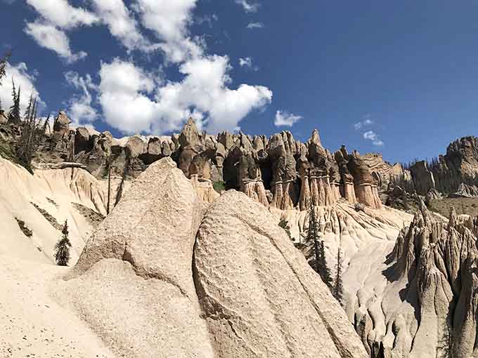 These ancient hoodoos cluster together, their weathered forms creating a landscape that defies belief and cameras alike.
