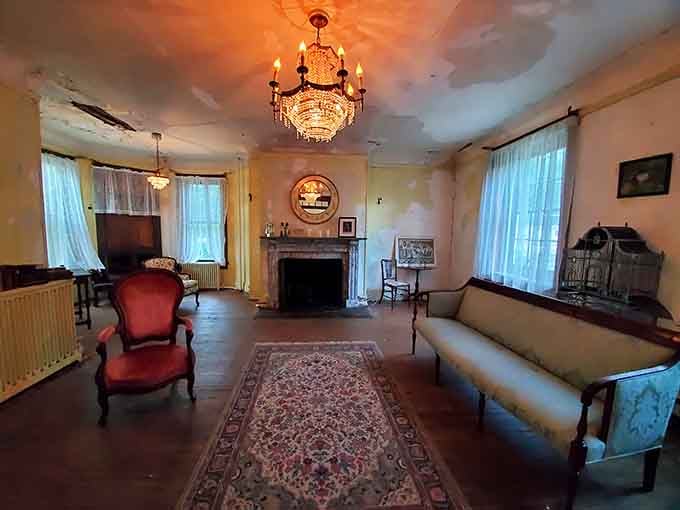 That crystal chandelier still sparkles in rooms where elegant gatherings once happened, before abandonment claimed the grand estate.