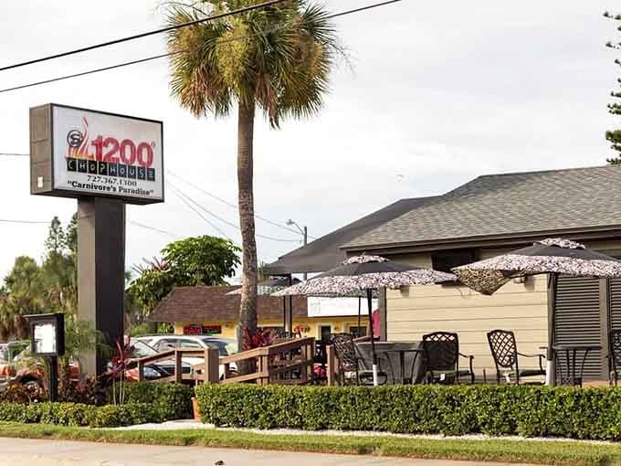 The casual deck setup with colorful umbrellas proves great steaks don't need stuffy atmospheres to shine.