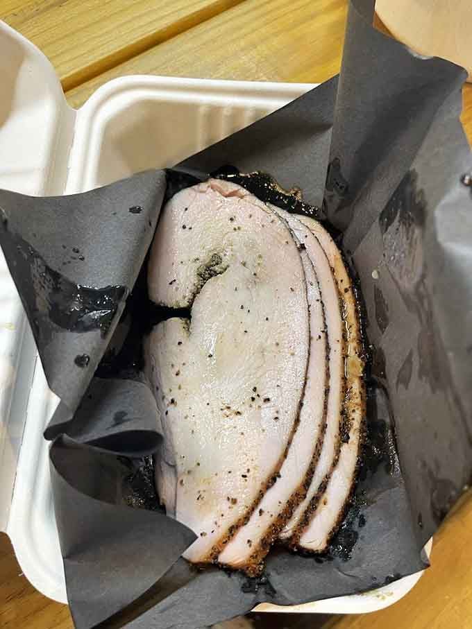Sliced smoked turkey that's moist and tender, proving poultry deserves respect at the barbecue table too.