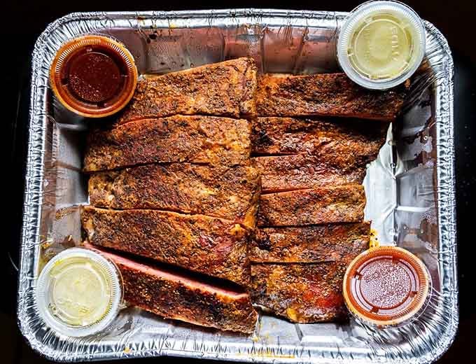St. Louis-style ribs lined up like edible dominoes, each one more perfectly seasoned than the last.