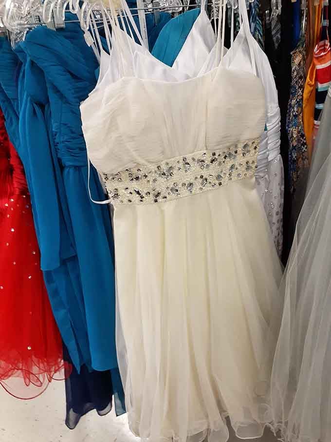 Formal dresses hanging here like Cinderella's closet had a clearance sale, glass slippers sold separately.