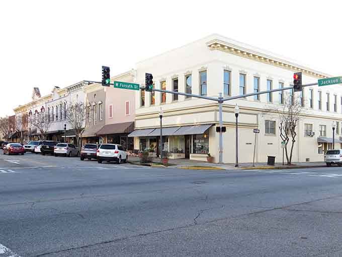 Corner buildings and traffic lights frame a downtown where people still park and walk instead of just driving through.