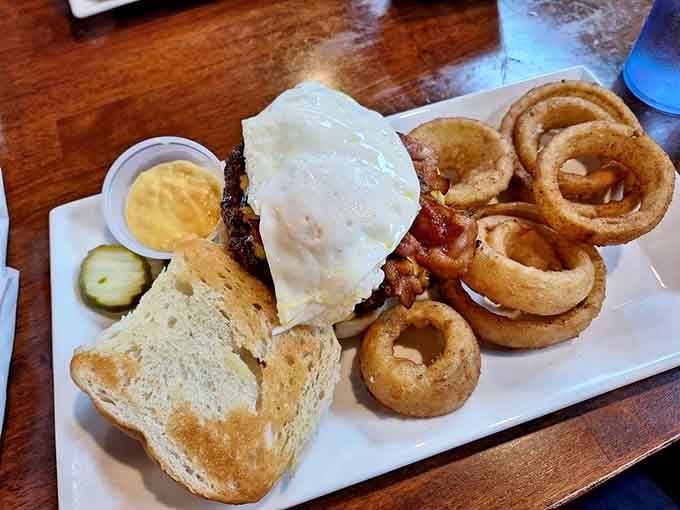 The Sunrise Burger with onion rings shows that some restaurants understand the assignment and then exceed all reasonable expectations for deliciousness.