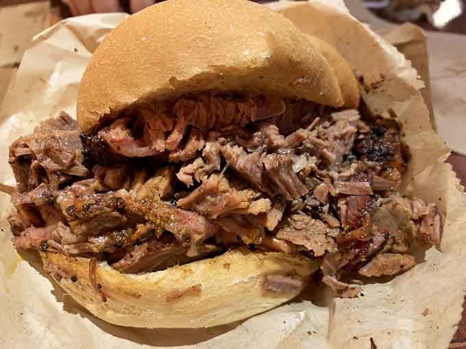 Piled high with smoky shredded meat, this sandwich is basically happiness between two buns, no exaggeration needed here.
