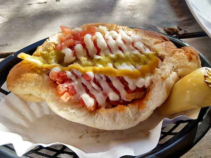 Look at those layers of bacon, beans, and toppings creating a masterpiece you'll need extra napkins for.