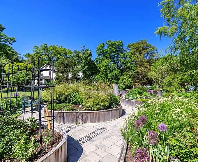 The accessible garden paths wind through raised beds bursting with color and possibility for your own yard.