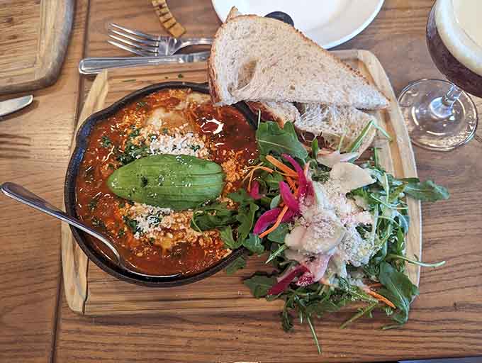 Shakshuka arrives like a warm hug in a skillet, eggs poached in spiced tomato heaven with bread for dipping.