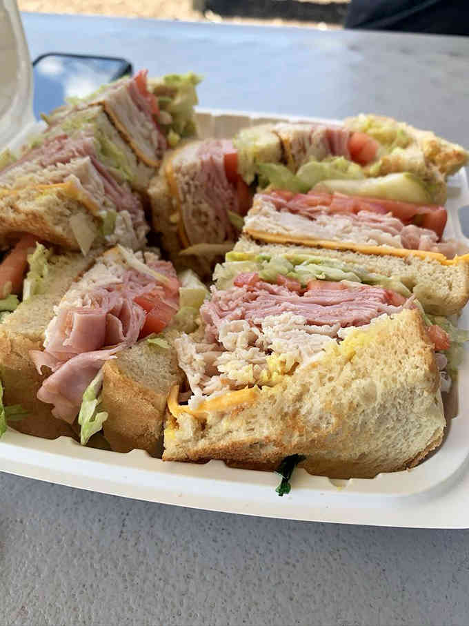 Layers of deli meat, cheese, and crisp lettuce make this club sandwich a architectural marvel worth photographing.