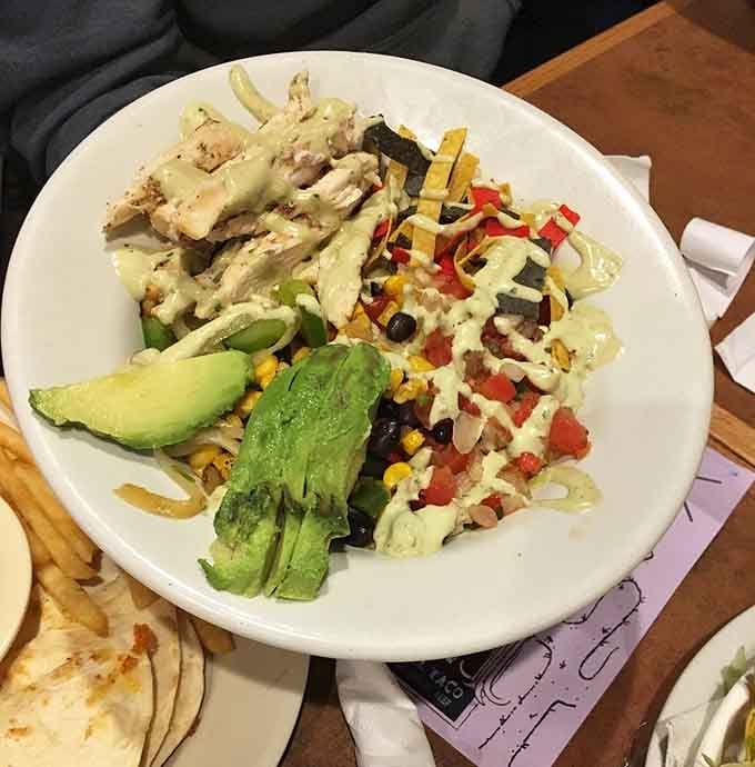 Grilled chicken atop a colorful salad that's almost too pretty to eat. Almost being the key word.