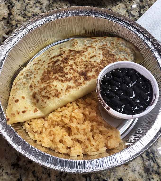 This quesadilla comes with rice and beans, turning a simple dish into a complete meal worth writing home about.