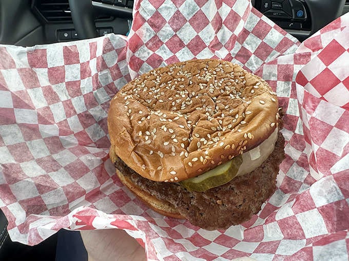 A sesame seed bun cradling a perfectly seasoned patty with pickles, this is what burgers looked like before they got complicated.