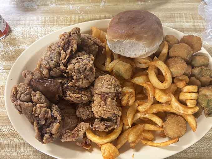 Fried gizzards and onion rings piled high next to a biscuit, because sometimes restraint is overrated at lunchtime.