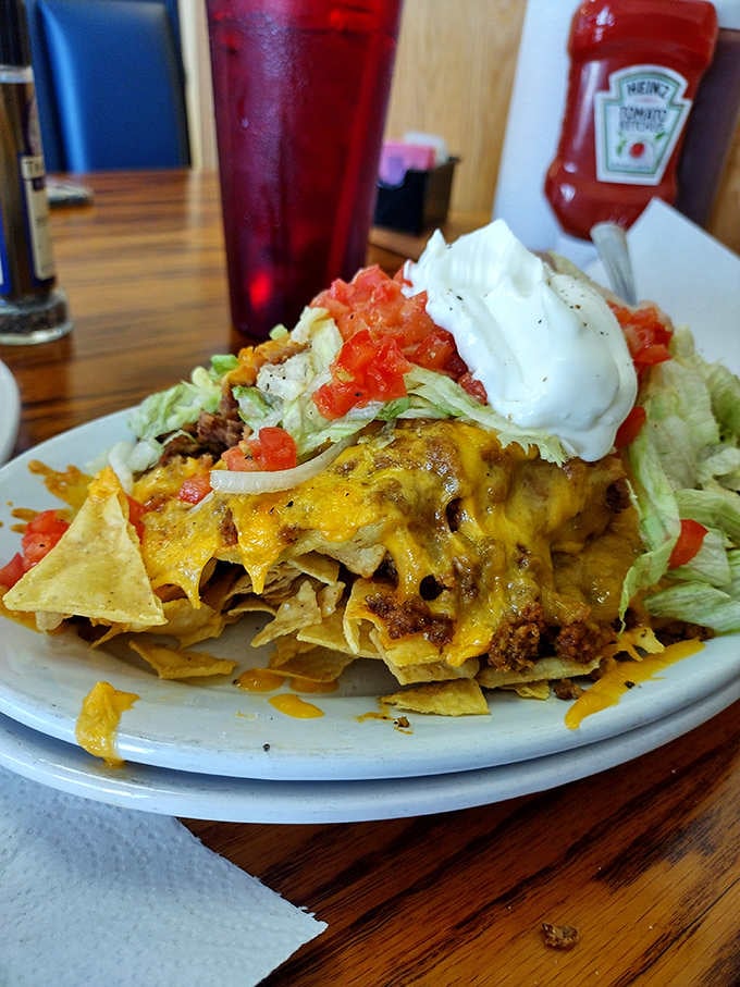 Nachos piled so high they've achieved architectural status, complete with sour cream summit and all the fixings.