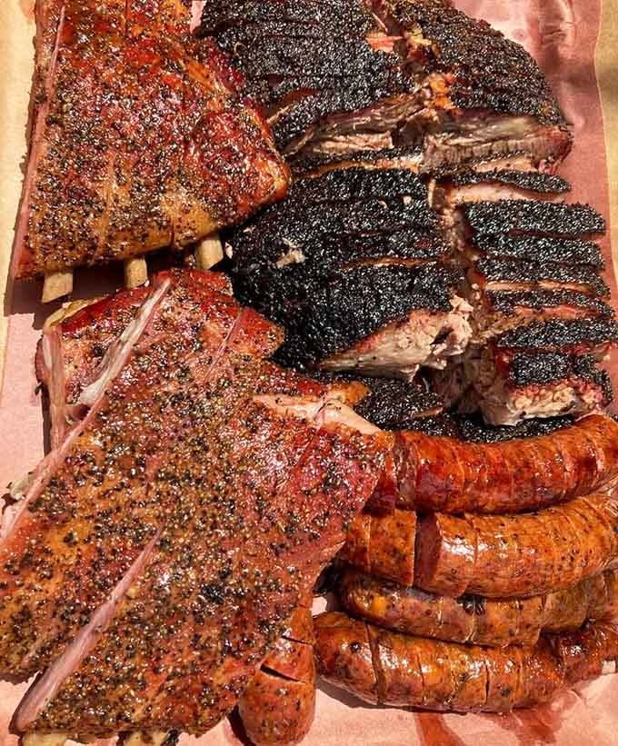 This meat platter showcases the full range of Black's smoking expertise, from ribs to brisket perfection.