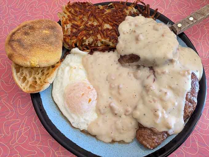 That homemade sausage gravy cascading over chicken fried steak is basically a love letter written in breakfast form and deliciousness.