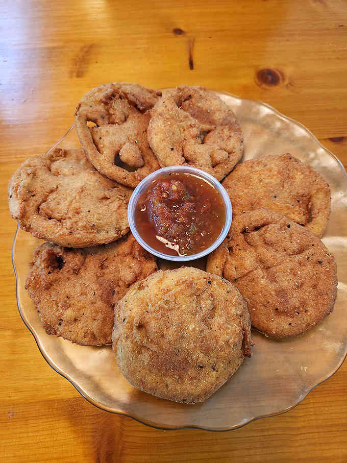 Fried green tomatoes arranged like golden medallions, each one a crispy tribute to Southern culinary genius and tradition.