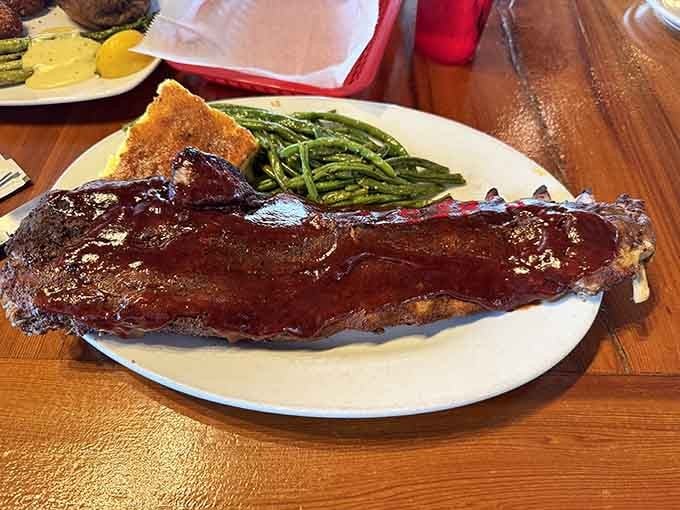 Ribs so tender they're practically falling off the bone in surrender, accompanied by green beans and Texas toast.