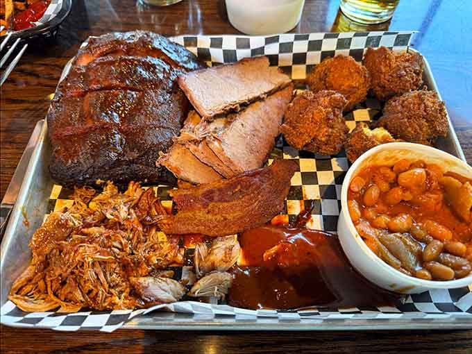 The ultimate meat platter loaded with ribs, brisket, pulled pork, hush puppies, and beans is pure indulgence personified.