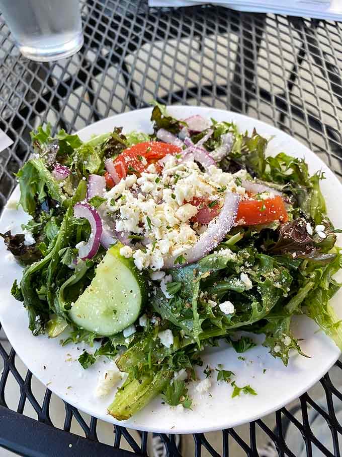 Feta crumbles cascading over fresh greens like edible confetti, proving salads can absolutely be the life of the party.