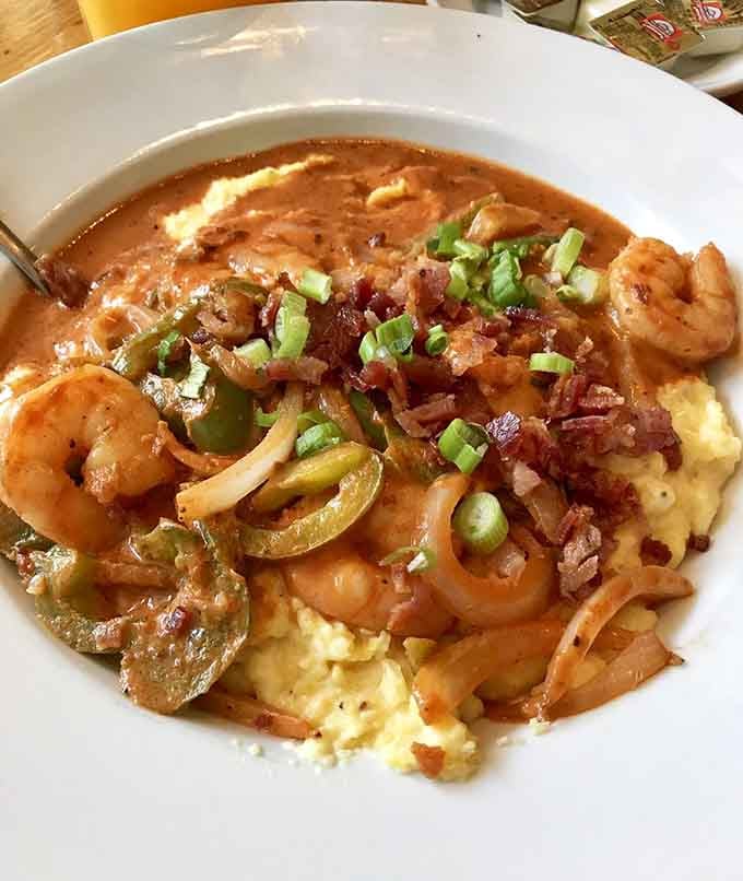 Shrimp and grits swimming in gravy that'll make you reconsider every life choice that delayed this moment.