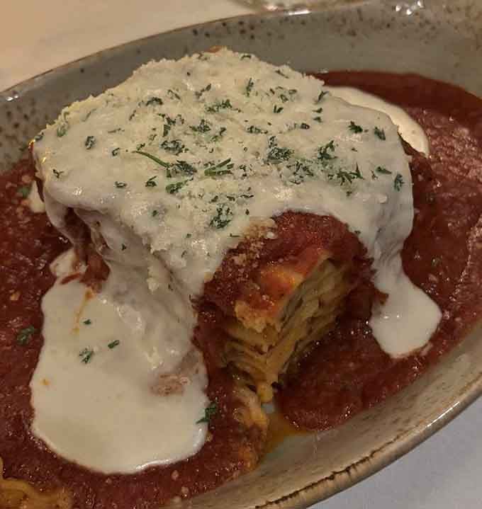 Layers of pasta, meat sauce, and multiple cheeses create the kind of lasagna that haunts your dreams forever.