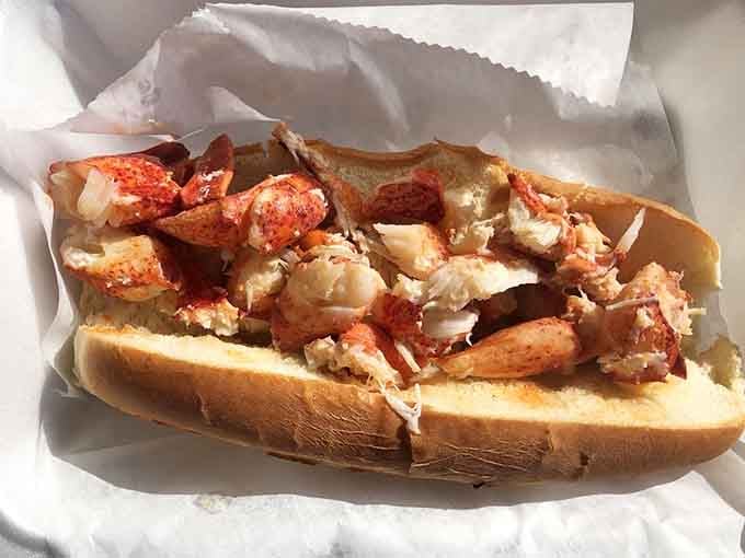 Lobster meat piled so high it's practically waving hello, nestled in a perfectly toasted bun.