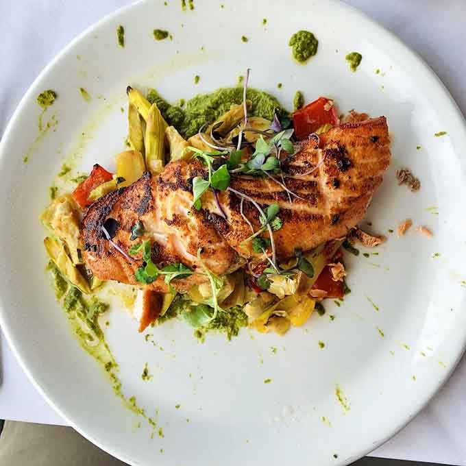 King salmon arrives beautifully plated, looking almost too pretty to eat until your fork disagrees with that assessment.