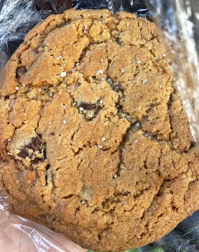 A chocolate chip cookie the size of your face, because apparently portion control took a permanent vacation here.