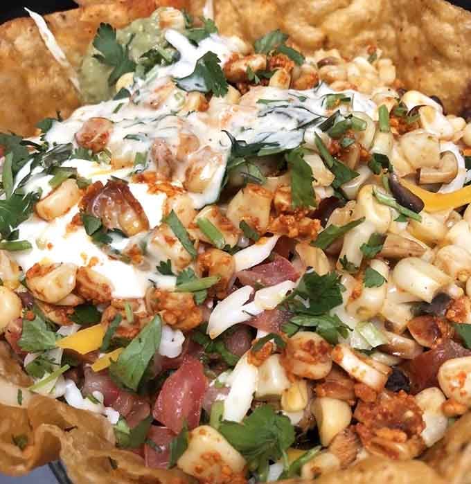 That chicken tostada is piled so high with toppings, you'll need an engineering degree to eat it properly.