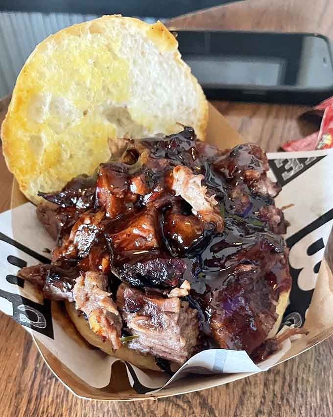 Brisket piled high on a bun with a side of hush puppies, because sometimes simple is absolutely perfect.