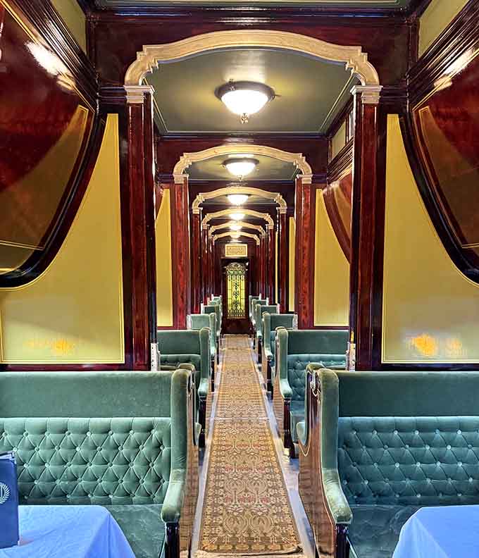 Step inside this restored railway car where polished wood and tufted seats create elegance that modern commuters can only dream about.
