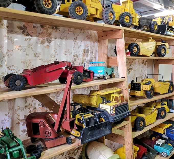 Vintage toy tractors lined up like a miniature construction site, triggering nostalgia in anyone over fifty.