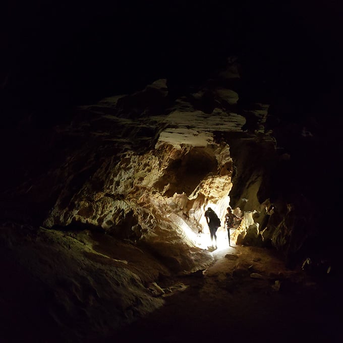 Deep in the belly of the mountain, explorers become tiny specks in geological grandeur.