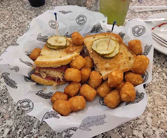 Tater tots surrounding a sandwich like tiny golden bodyguards&mdash;this is comfort food that takes its job very seriously indeed.