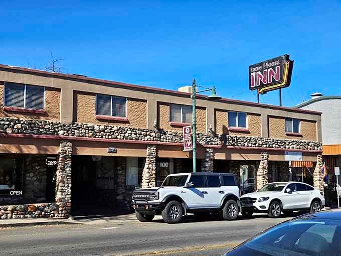 The Iron Horse Inn stands ready to host weary travelers, its vintage sign a beacon for those seeking small-town hospitality.
