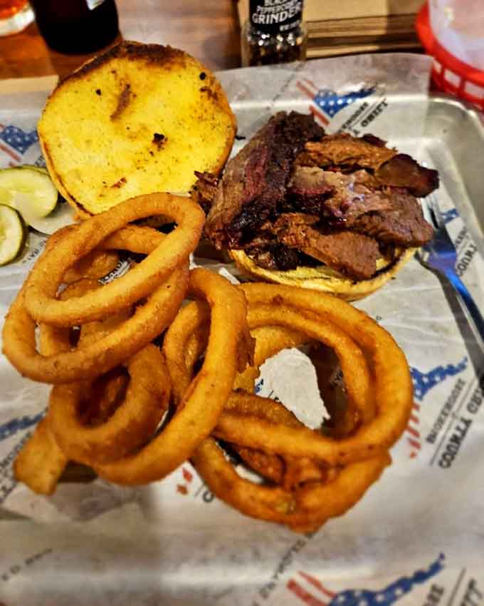 Brisket piled high on a bun with onion rings that could make a grown person weep tears of pure joy.