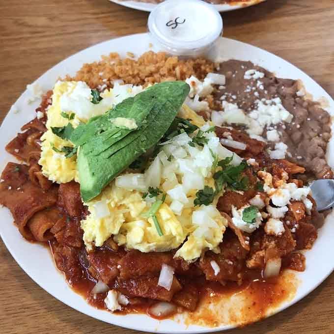 Chilaquiles topped with avocado and eggs, proving breakfast doesn't have to choose between hearty and flavorful.