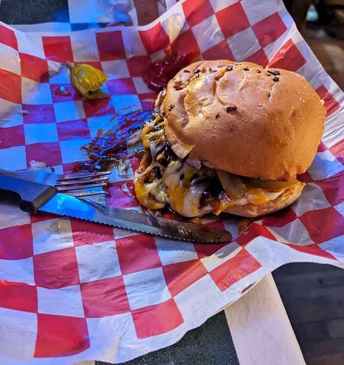 The hickory burger arrives with caramelized onions piled so high, structural engineering becomes part of your dining experience.
