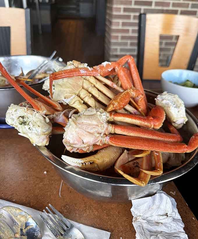 Snow crab legs piled high enough to make you wonder if they misunderstood what "generous" means.