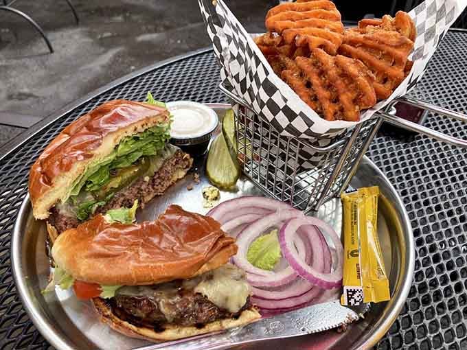 Waffle fries and a burger that understands the assignment, served on a tray that's seen some serious action.