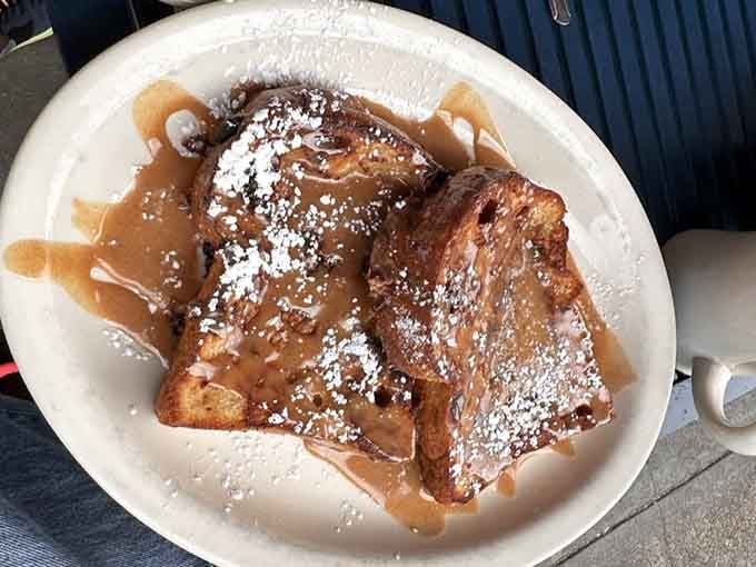 French toast dusted with powdered sugar like fresh snow on delicious, eggy mountains of carbohydrate heaven.