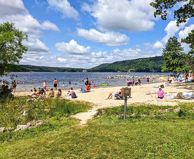 Sandy beaches meet mountain lake water in a combination that shouldn't work this well, but does.