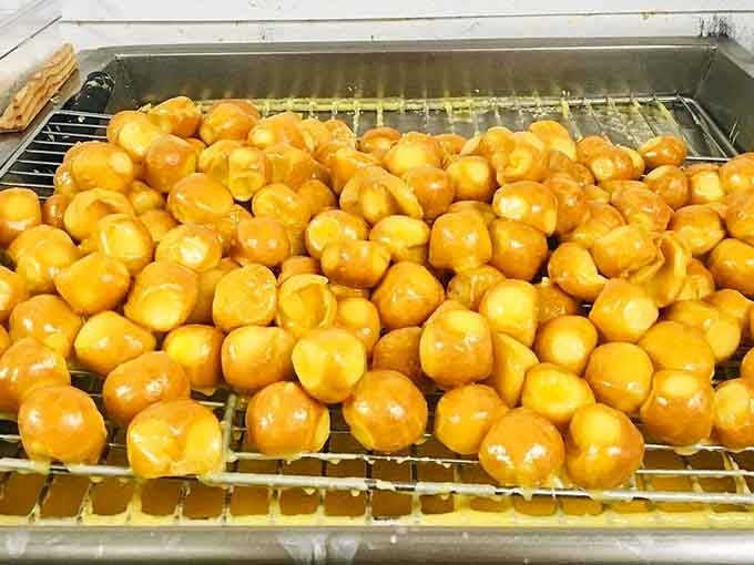 A sea of golden glazed donut holes, because sometimes good things really do come in small packages.