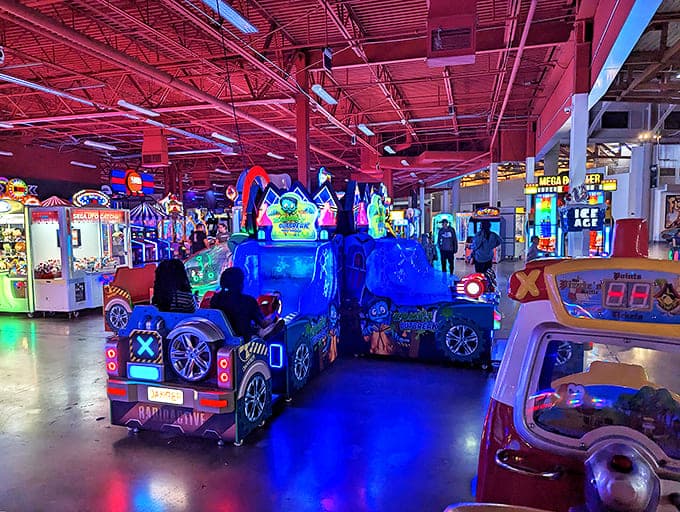 Glowing arcade rides pulse with electric blue energy, calling to anyone who ever fed quarters into Pac-Man.